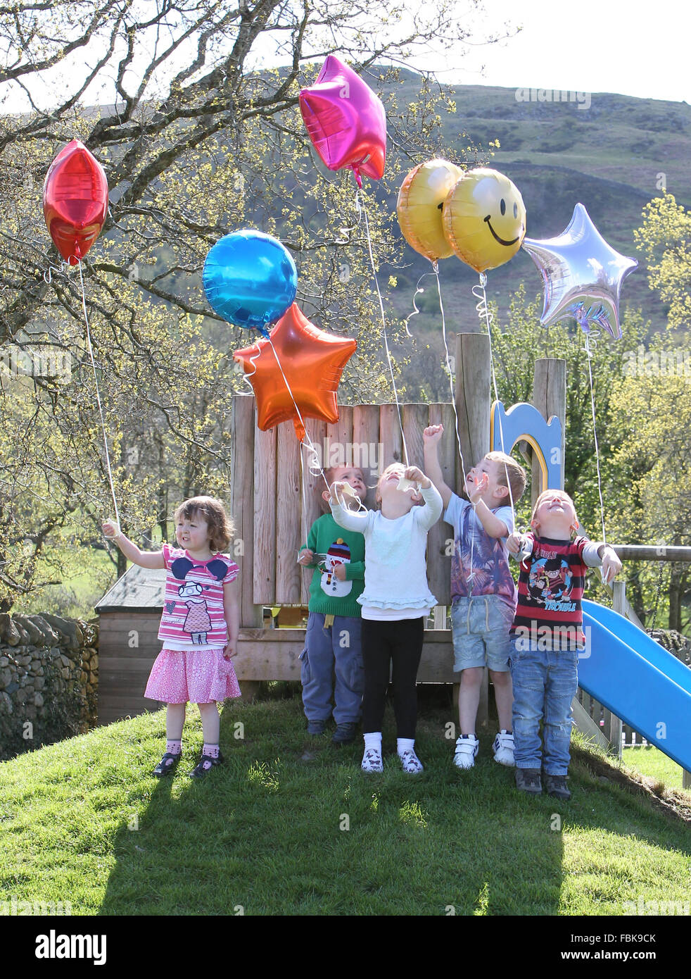 Children playing with balloons at a nursery having fun Stock Photo - Alamy