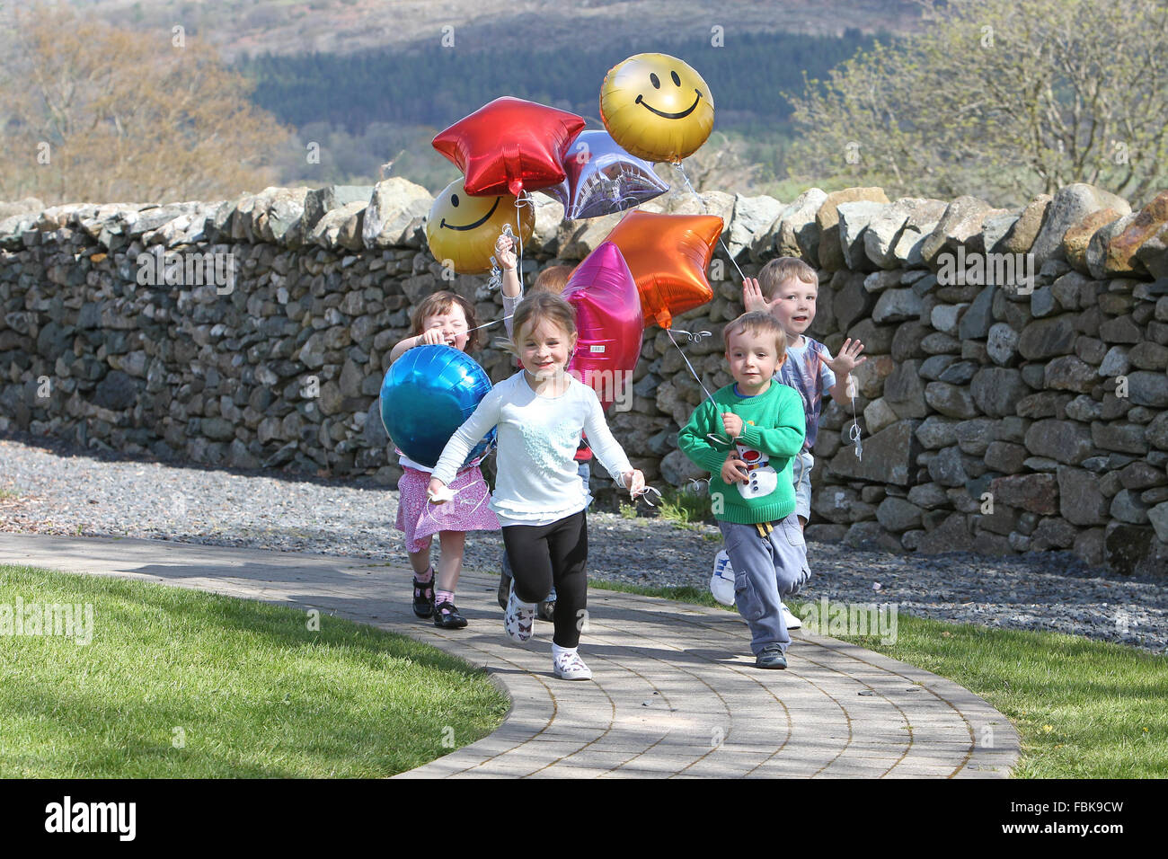 Children playing with balloons at a nursery Stock Photo - Alamy