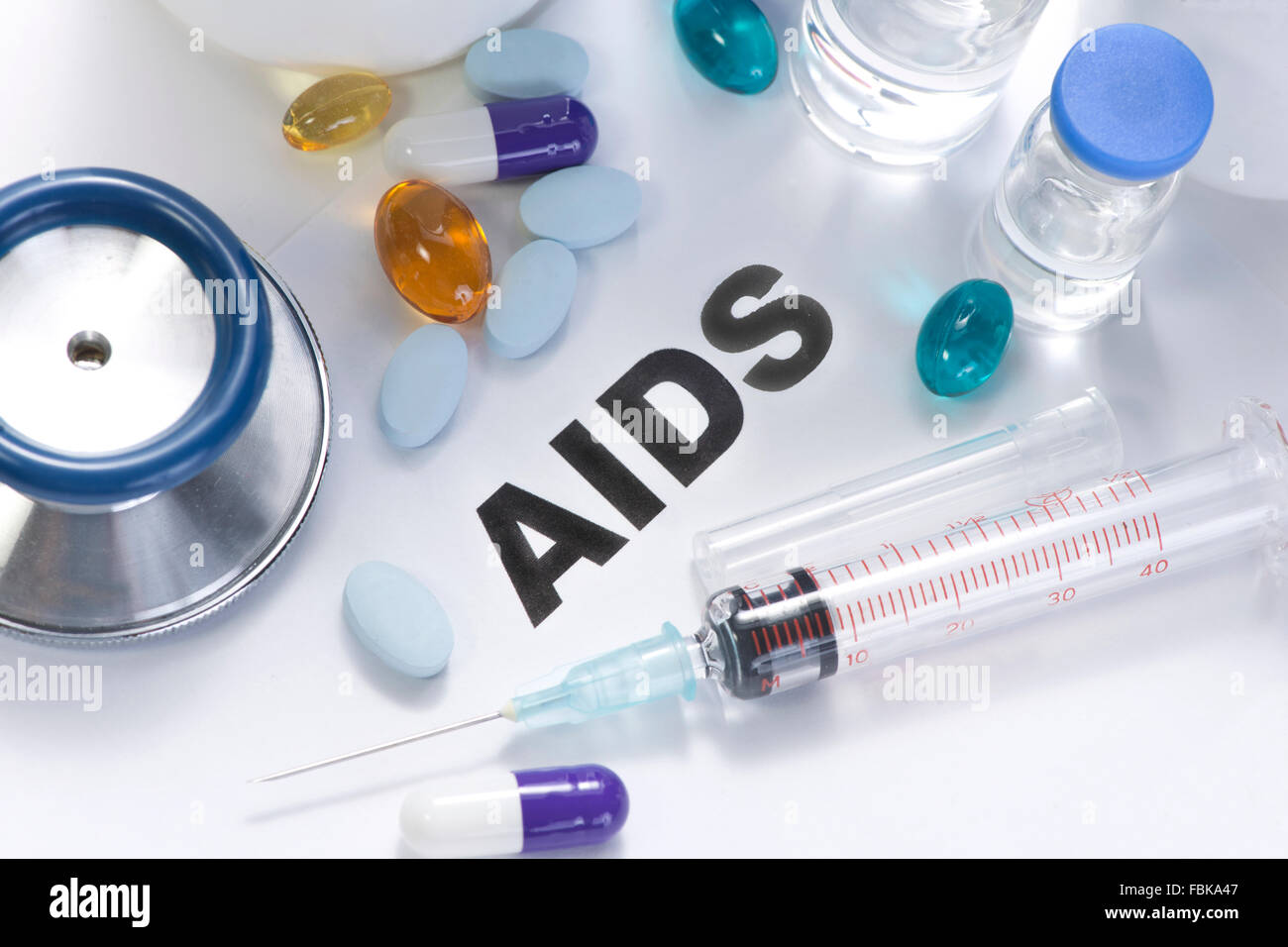 AIDS concept photo with stethoscope, pills, syringe and vials Stock ...