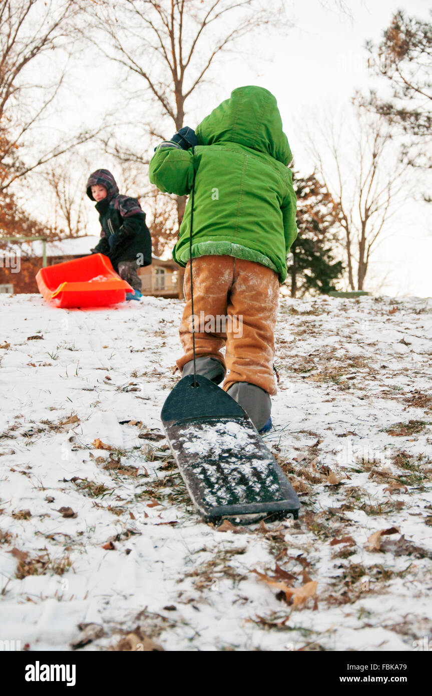 Boys pulling sleds hi-res stock photography and images - Alamy