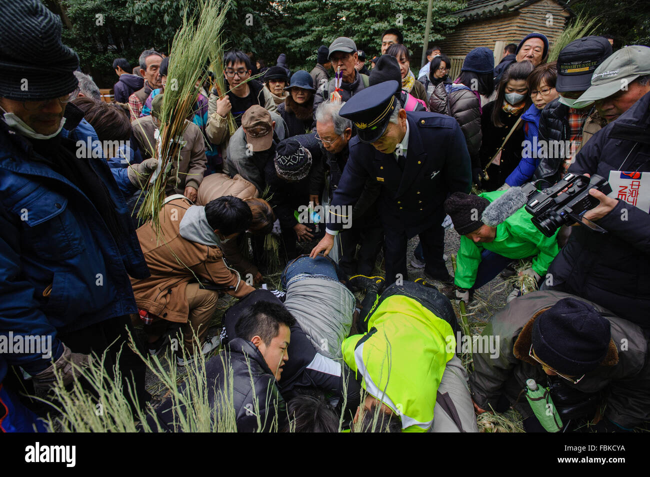 JANUARY 15, 2016 - People struggle on the ground to grab pieces of the ...