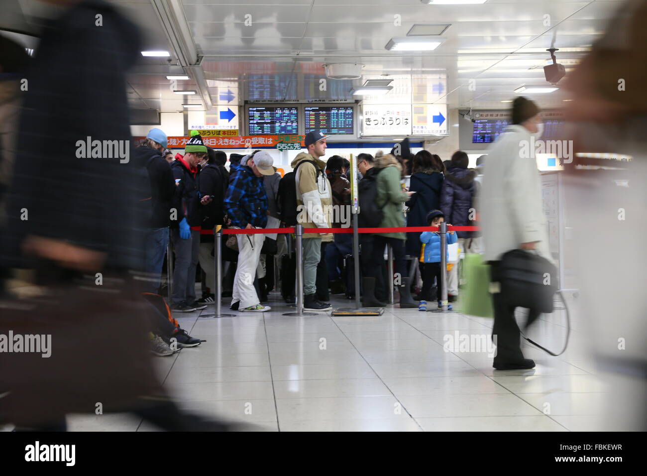 Passengers wait in Tokyo Station as trains are delayed due to snow on ...