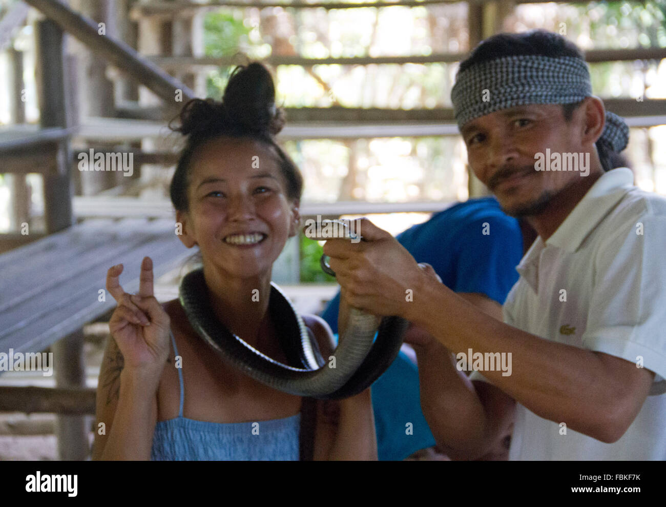Snake handlers and a tourist pose during a snake show at the Mae SA ...