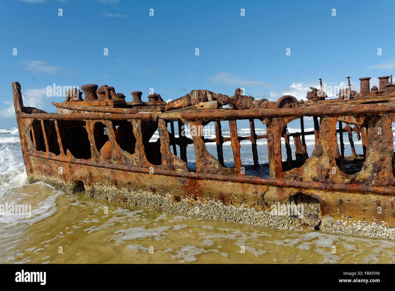 The rusting hulk of the SS Maheno lying on a beach on Fraser Island ...