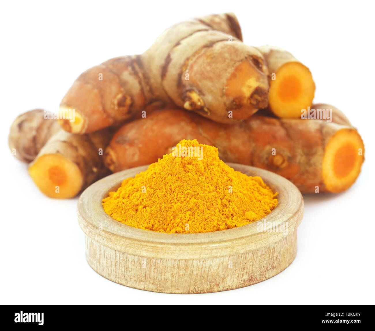 Raw and powdered turmeric over white background Stock Photo - Alamy