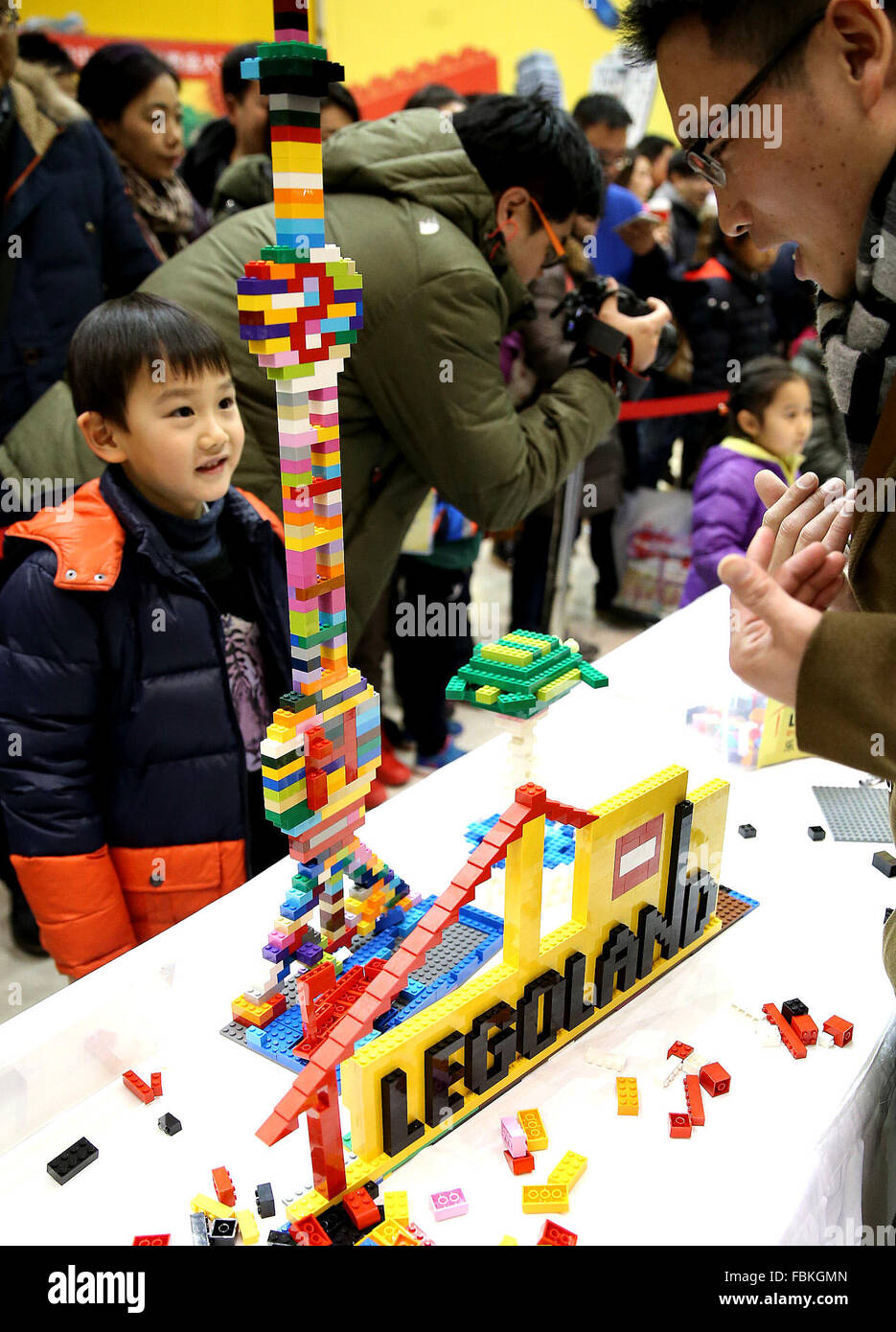 Shanghai, China. 17th Jan, 2016. A child listens to a participant ...