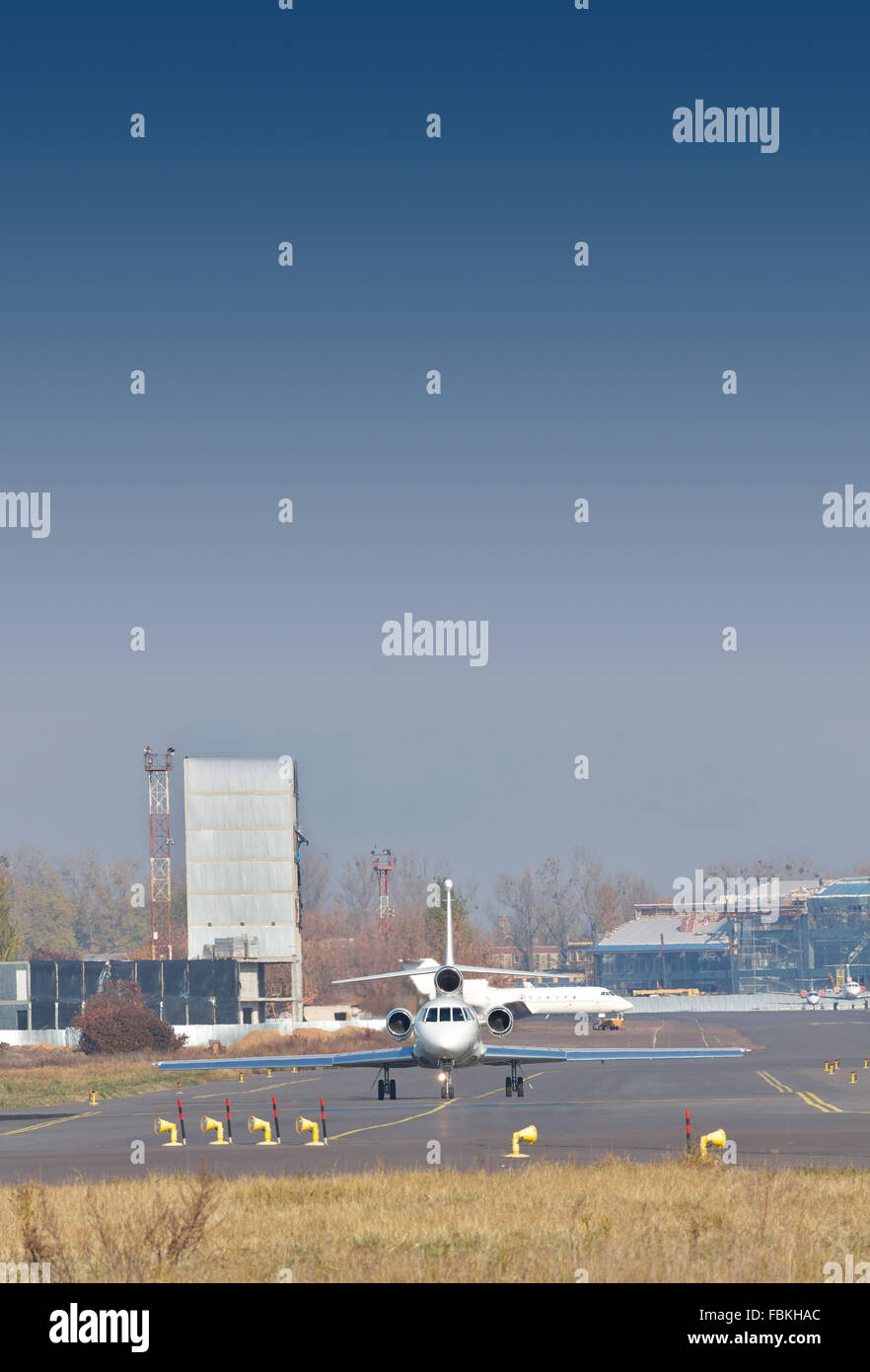 Business jet taxiing to the runway in the airport Stock Photo - Alamy