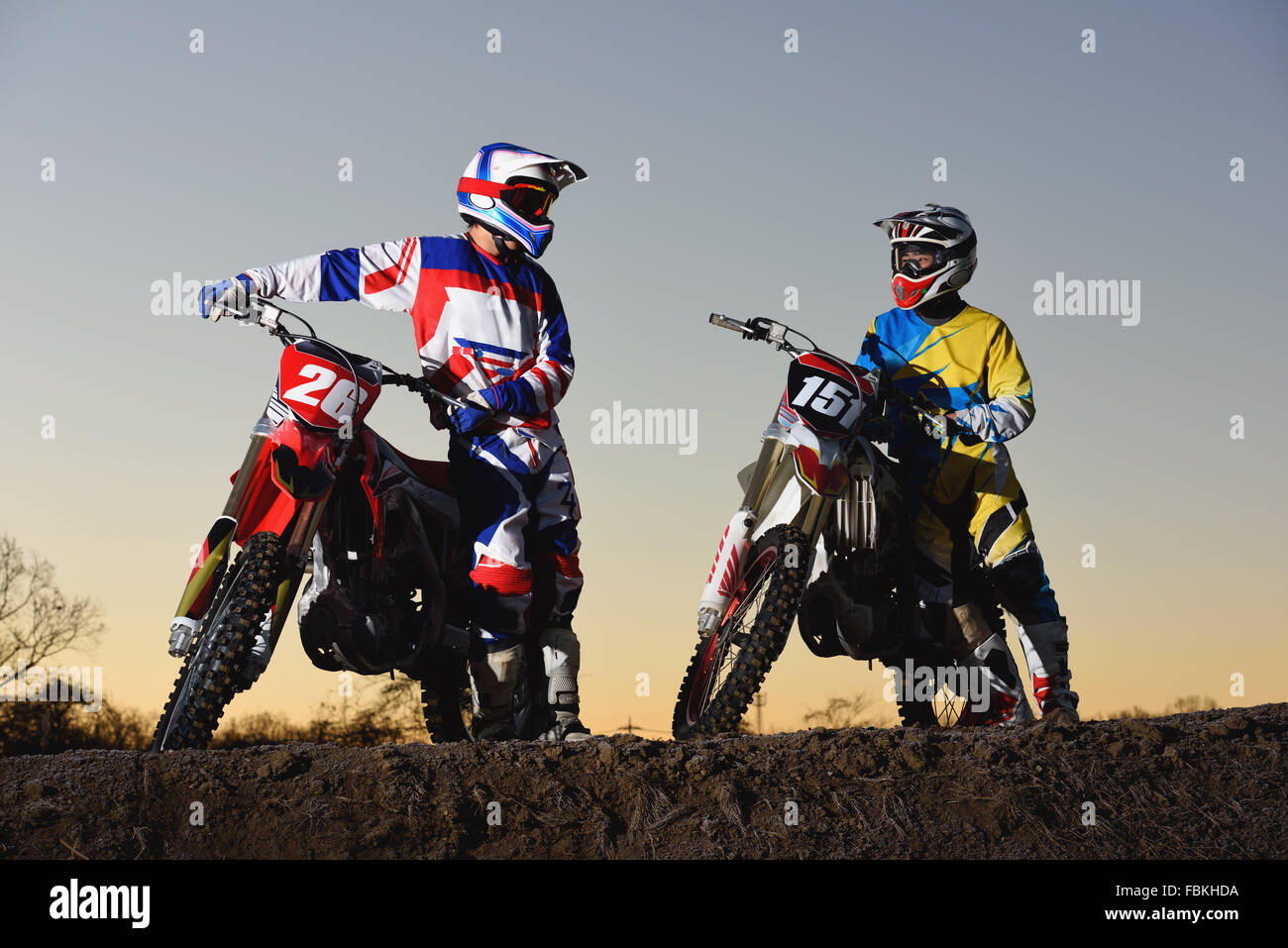 Motocross bikers on dirt track Stock Photo - Alamy