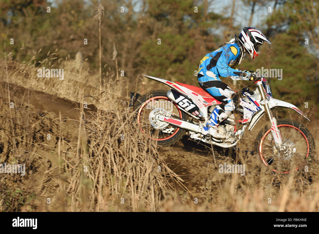 Motocross biker on dirt track Stock Photo - Alamy