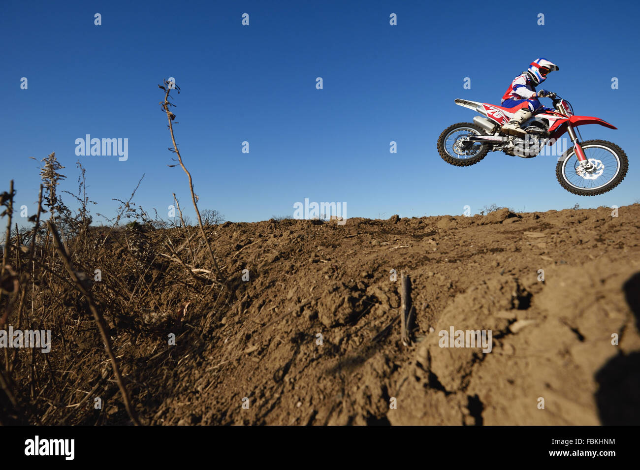 Motocross biker on dirt track Stock Photo - Alamy
