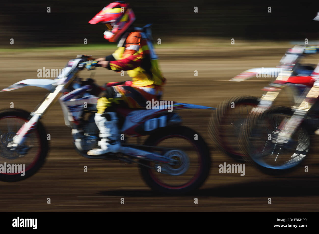 Motocross bikers on dirt track Stock Photo - Alamy