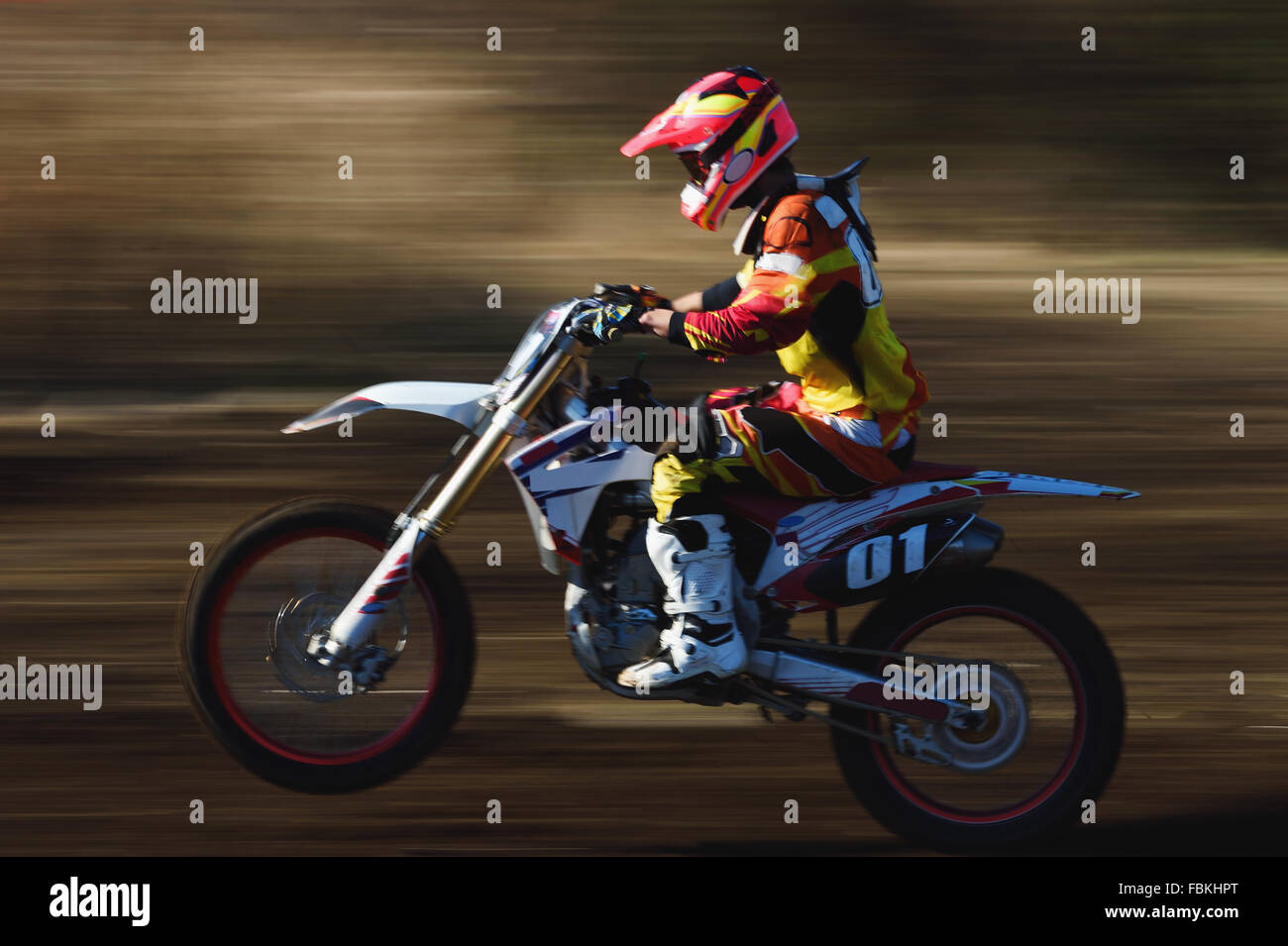 Motocross biker on dirt track Stock Photo - Alamy