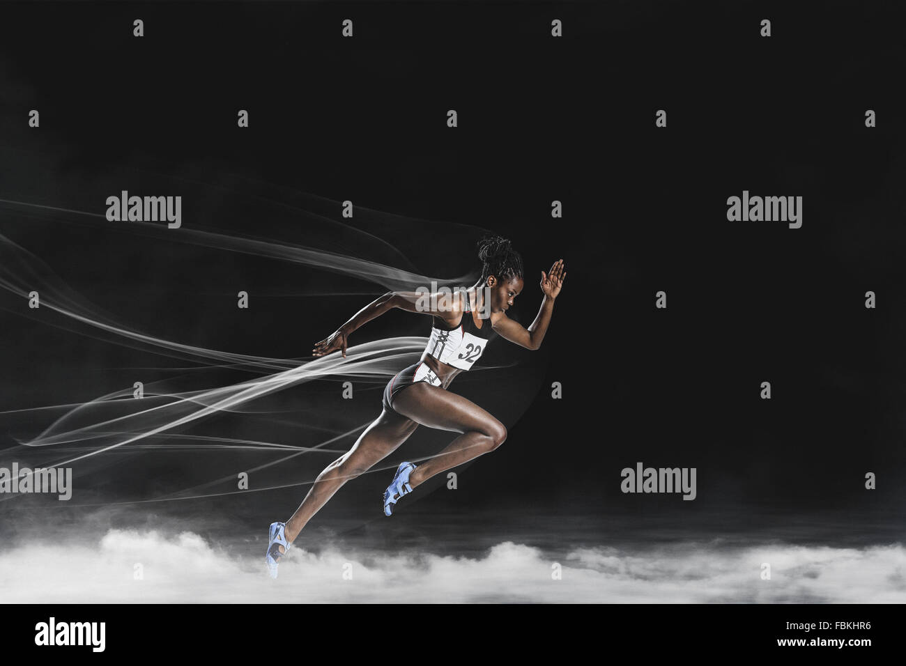 Athlete running in the smoke Stock Photo - Alamy