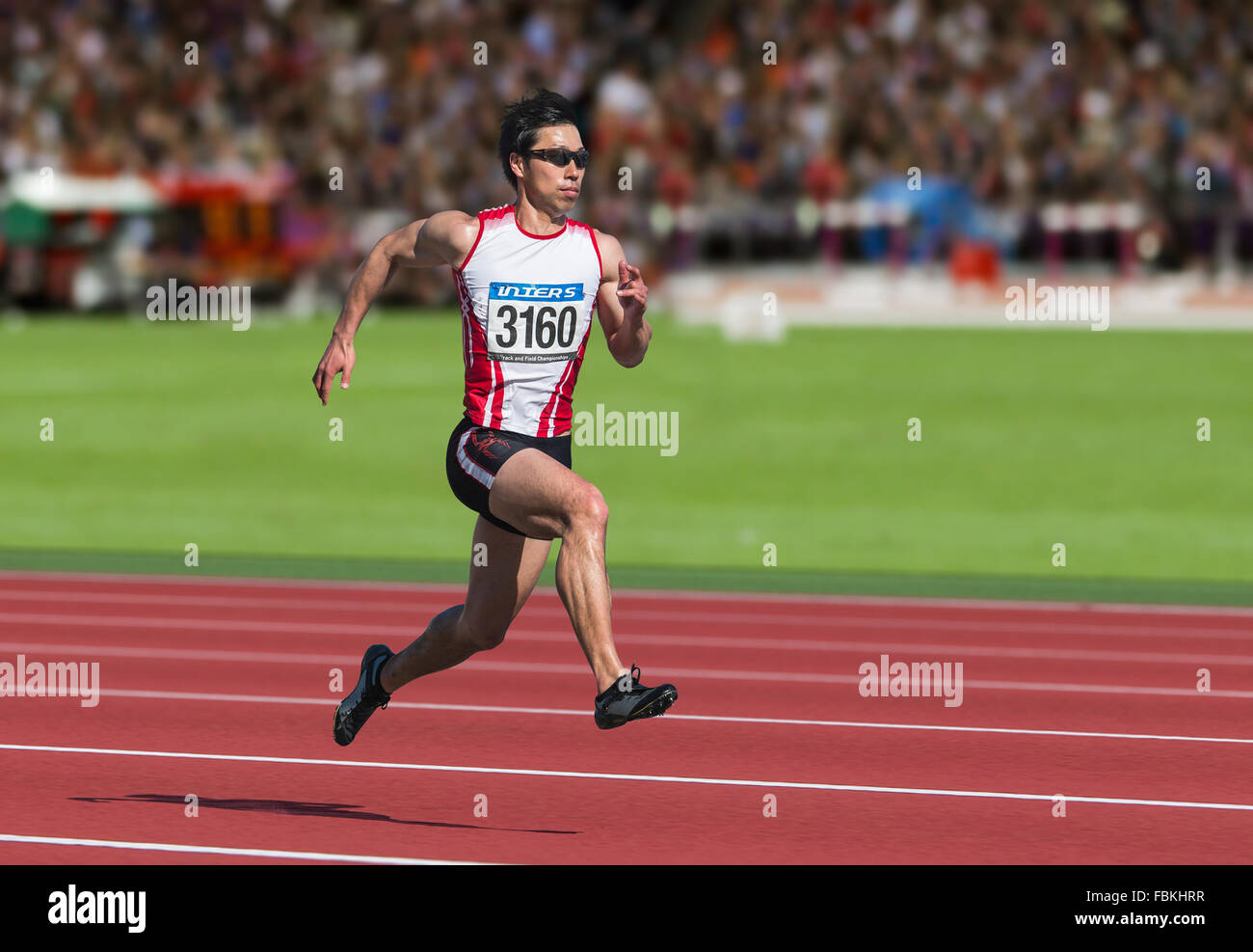 Japanese male sprinter running on track Stock Photo - Alamy