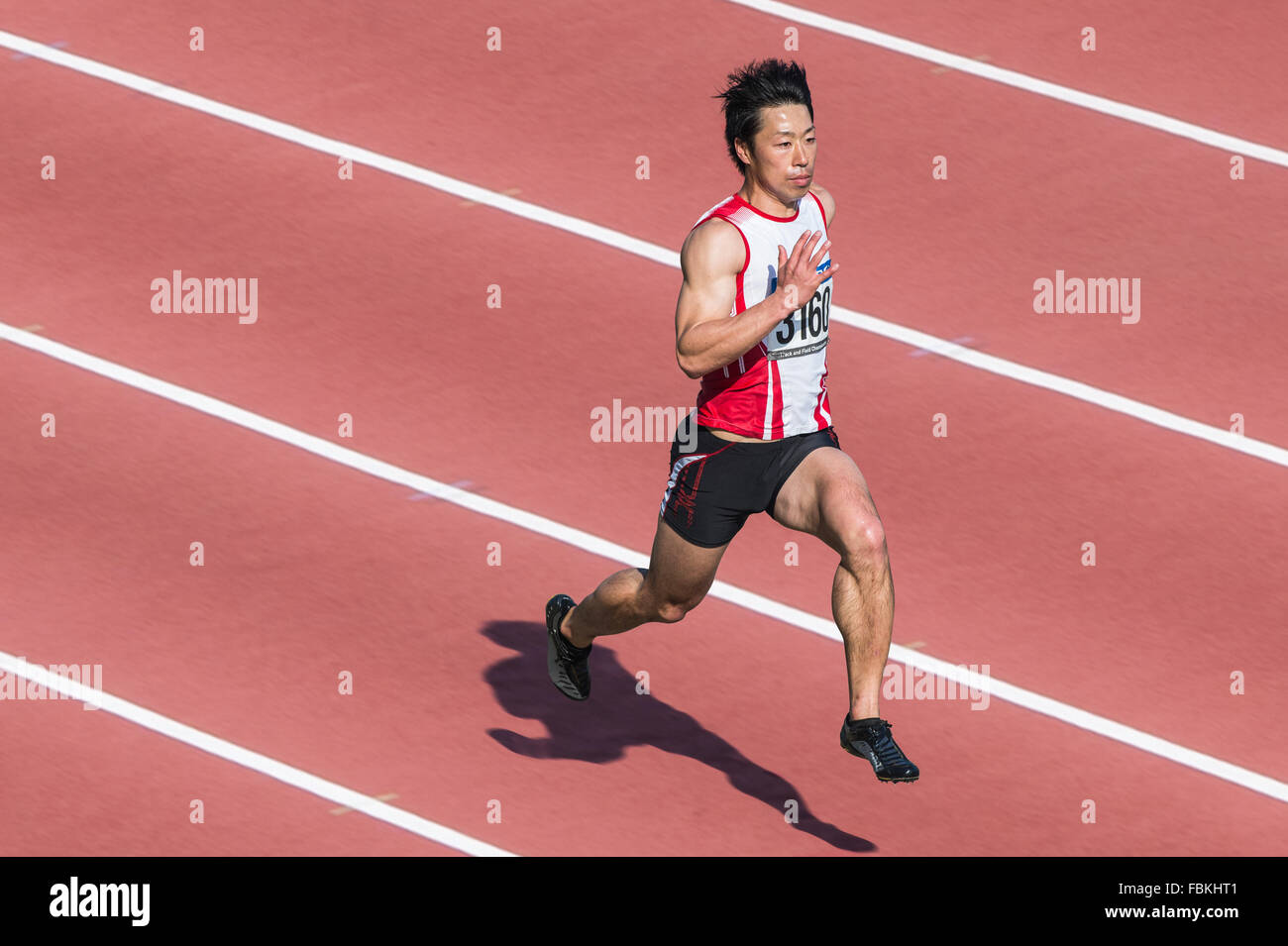 Japanese male sprinter running on track Stock Photo - Alamy