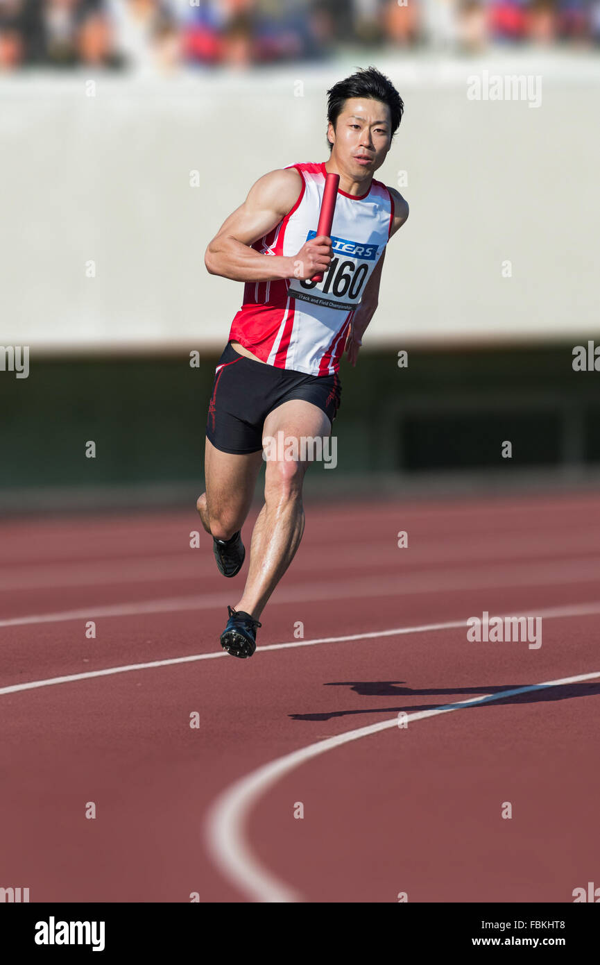 Japanese male sprinter running on track Stock Photo - Alamy