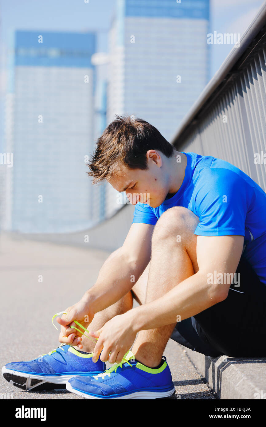 Young Caucasian man preparing to run in metropolitan area Stock Photo ...