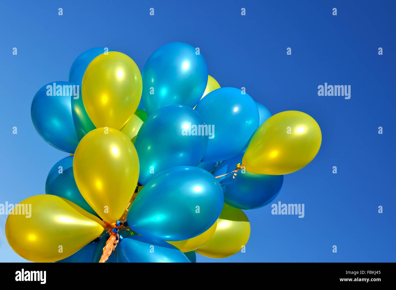 blue and yellow metallic balloons in the city festival Stock Photo - Alamy