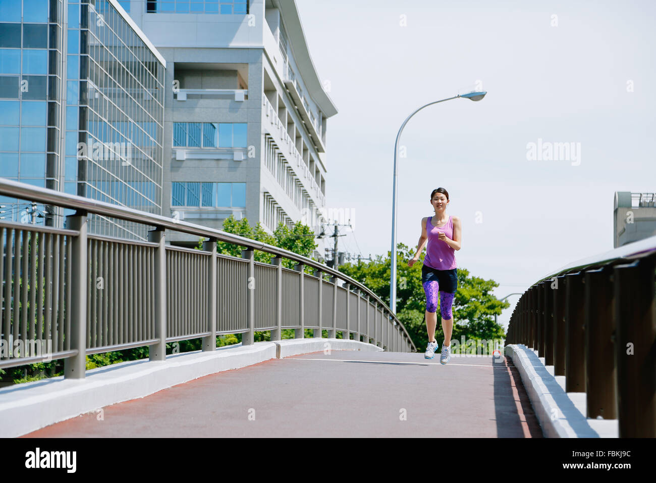 Young Japanese woman running downtown Tokyo Stock Photo - Alamy