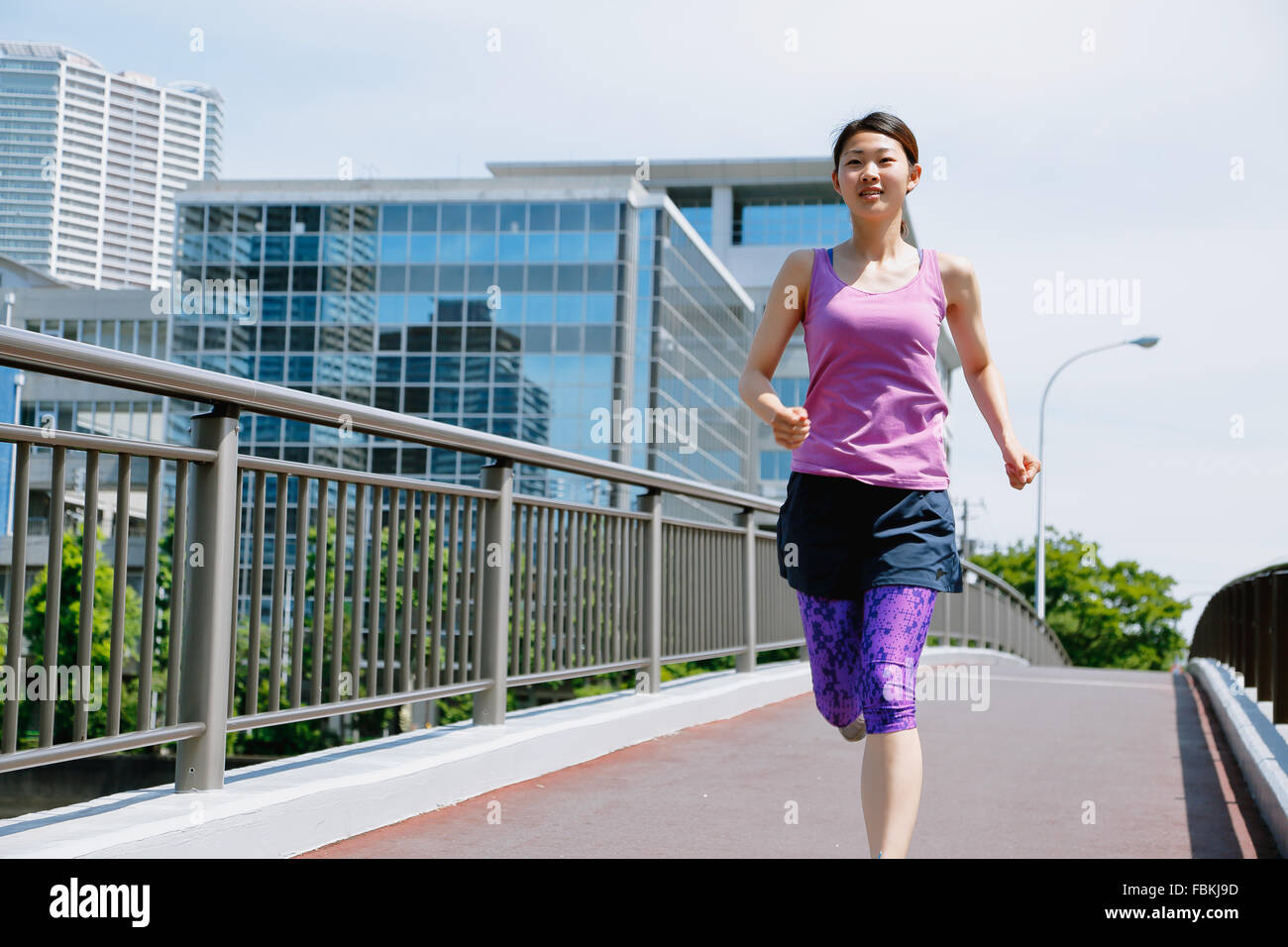 Young Japanese woman running downtown Tokyo Stock Photo - Alamy