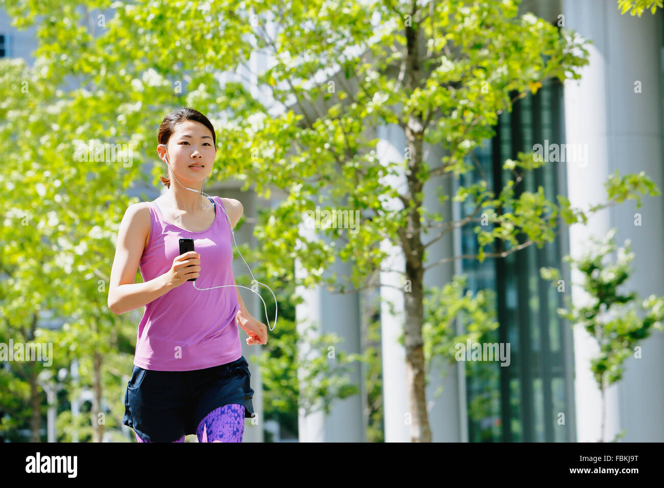 Young Japanese woman running downtown Tokyo Stock Photo - Alamy