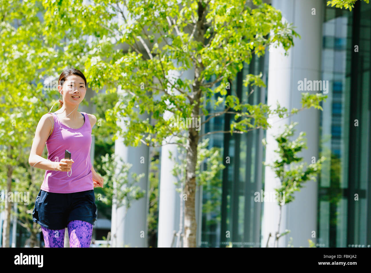 Young Japanese woman running downtown Tokyo Stock Photo - Alamy
