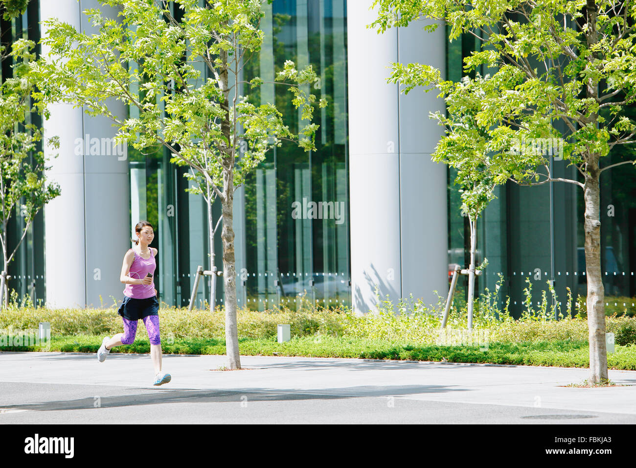 Young Japanese woman running downtown Tokyo Stock Photo - Alamy