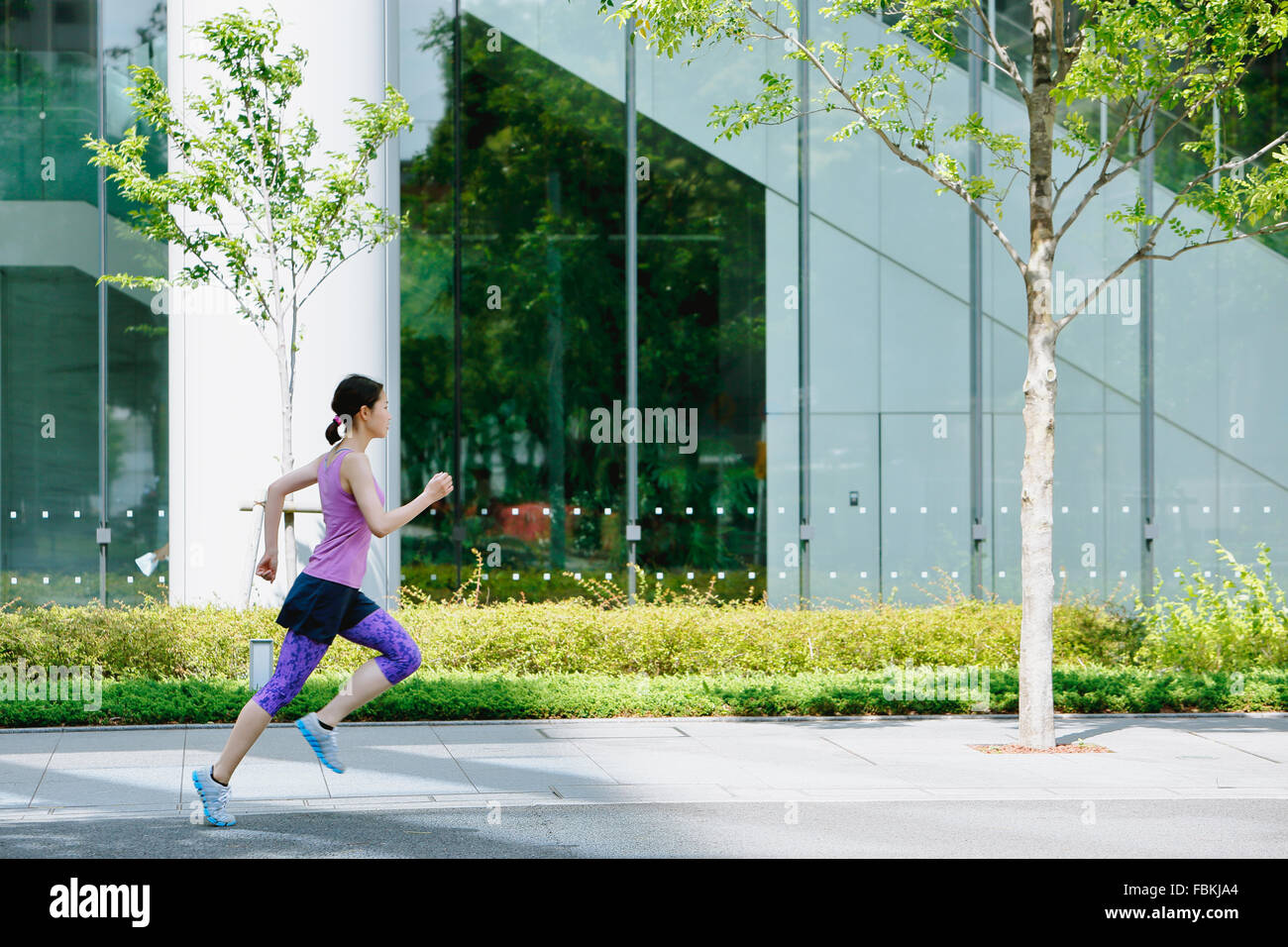 Young Japanese woman running downtown Tokyo Stock Photo - Alamy