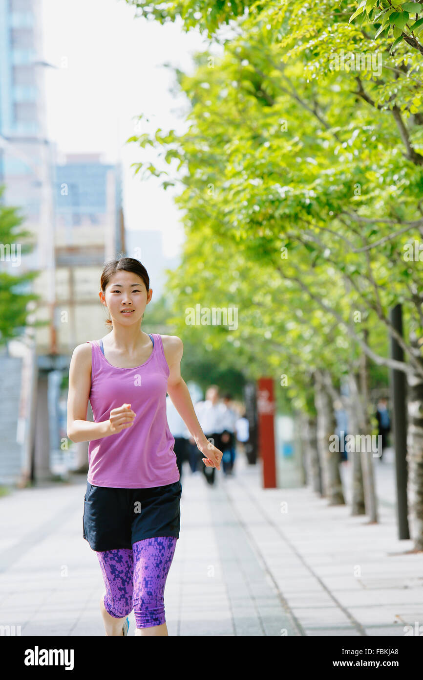 One woman running front hi-res stock photography and images - Alamy