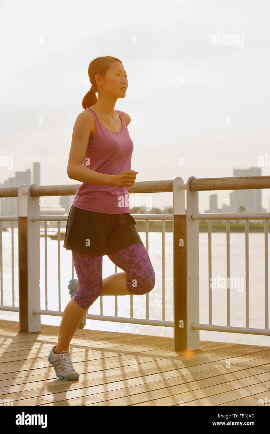 Young Japanese woman running downtown Tokyo Stock Photo - Alamy