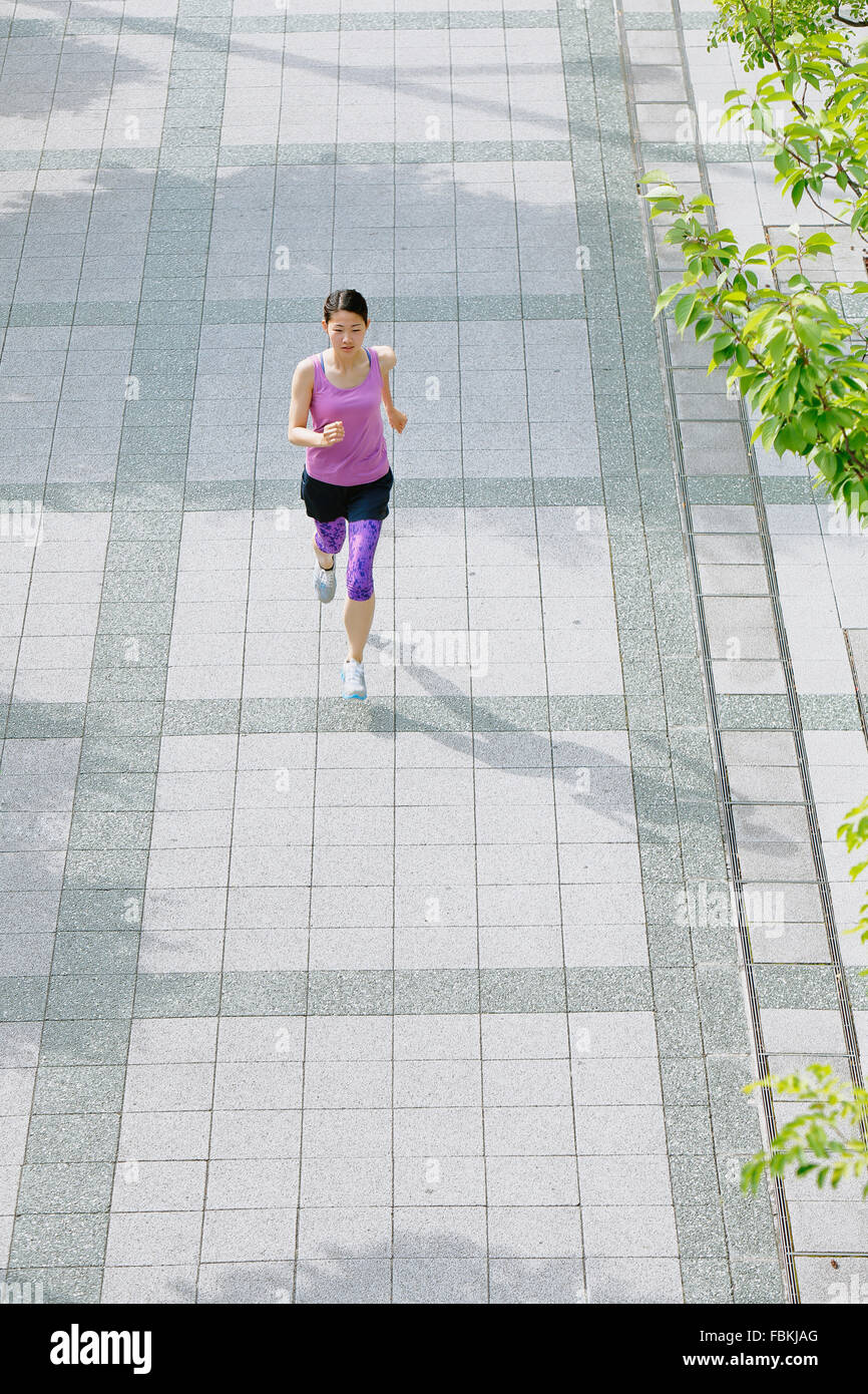 Young Japanese woman running downtown Tokyo Stock Photo - Alamy