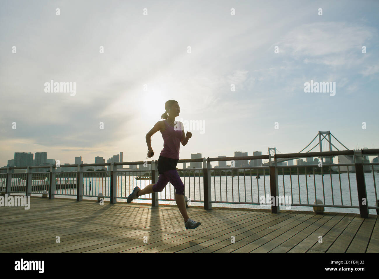 Young Japanese woman running downtown Tokyo Stock Photo - Alamy