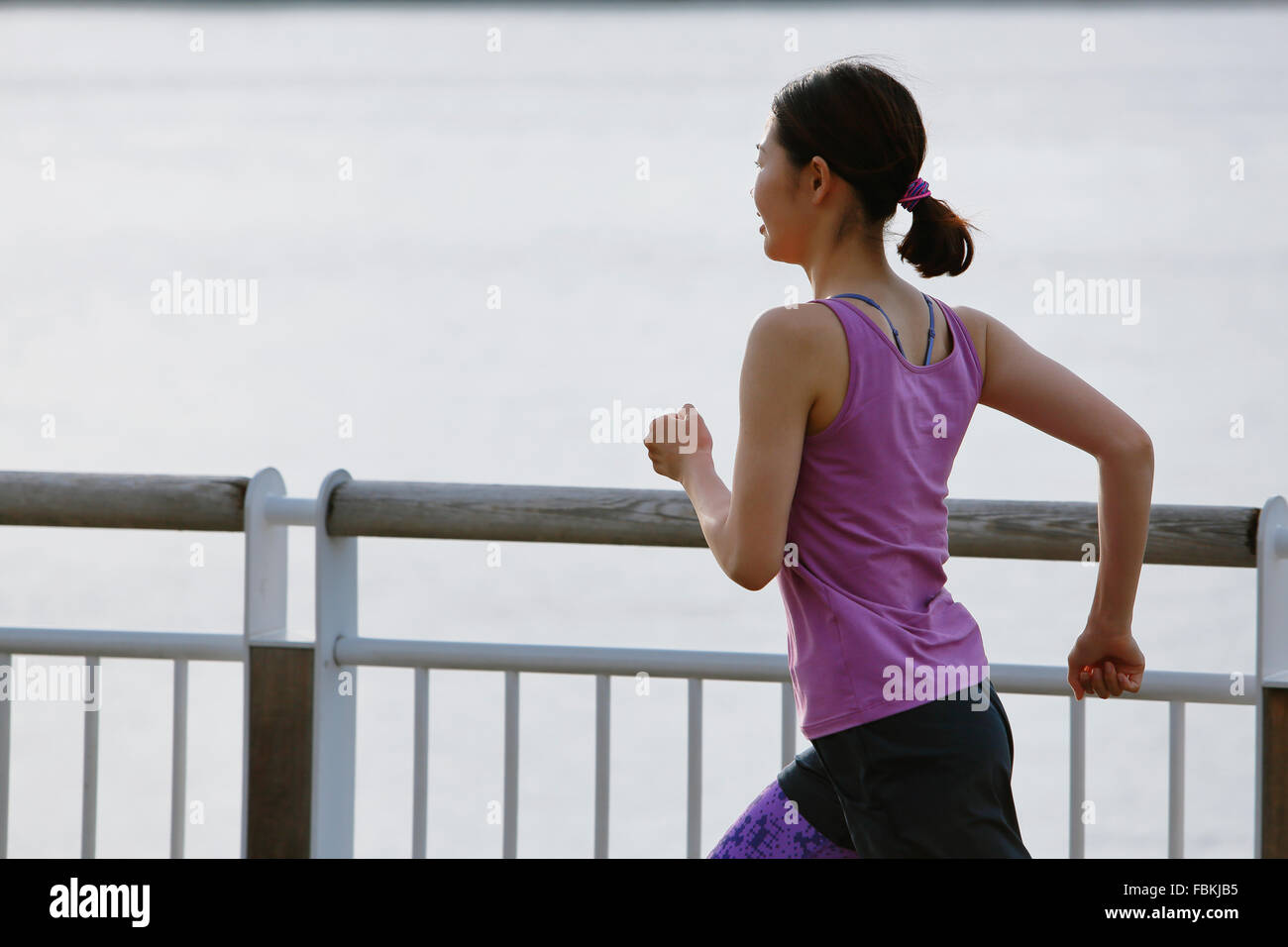 Young Japanese woman running downtown Tokyo Stock Photo - Alamy