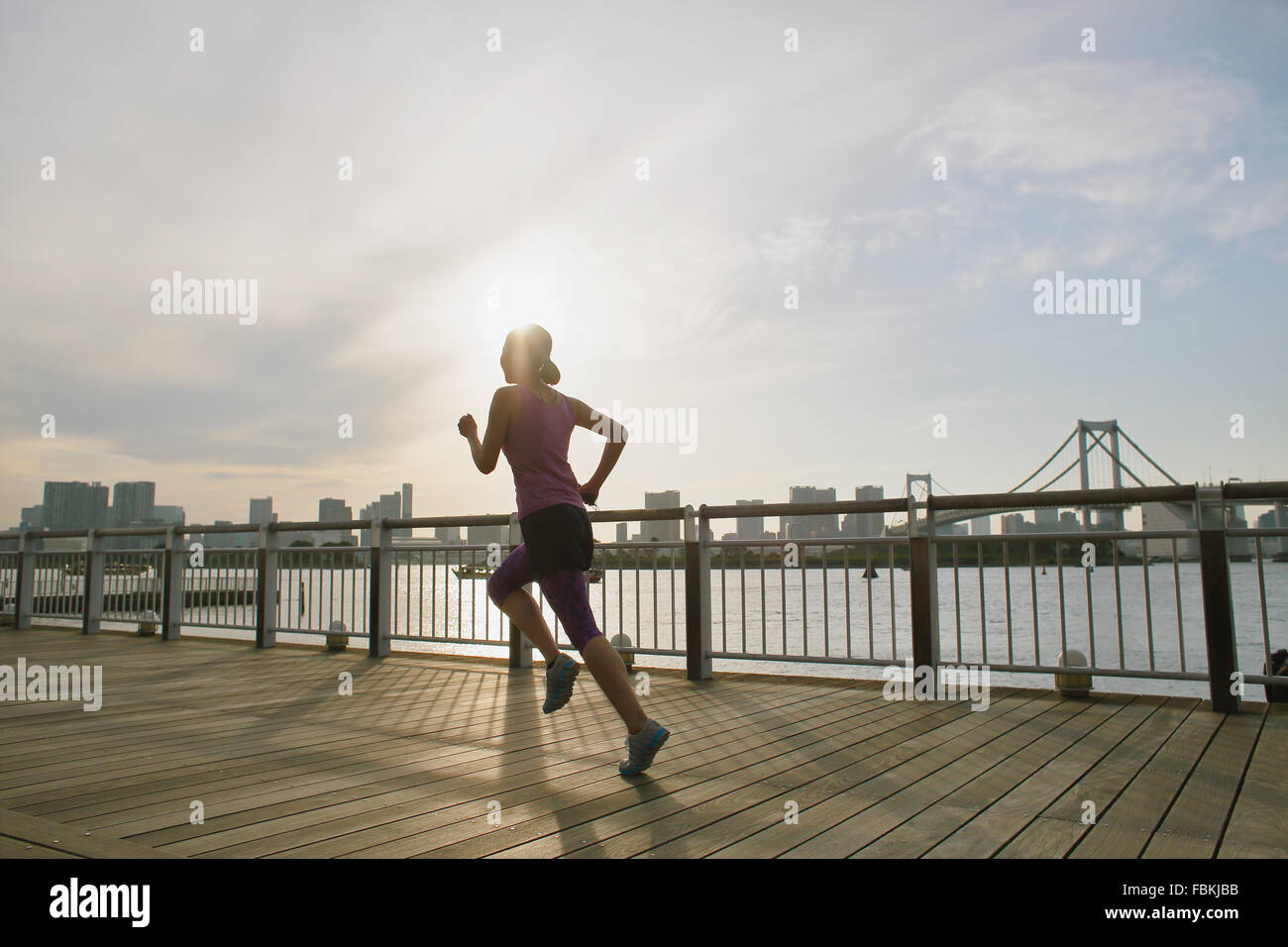 Young Japanese woman running downtown Tokyo Stock Photo - Alamy