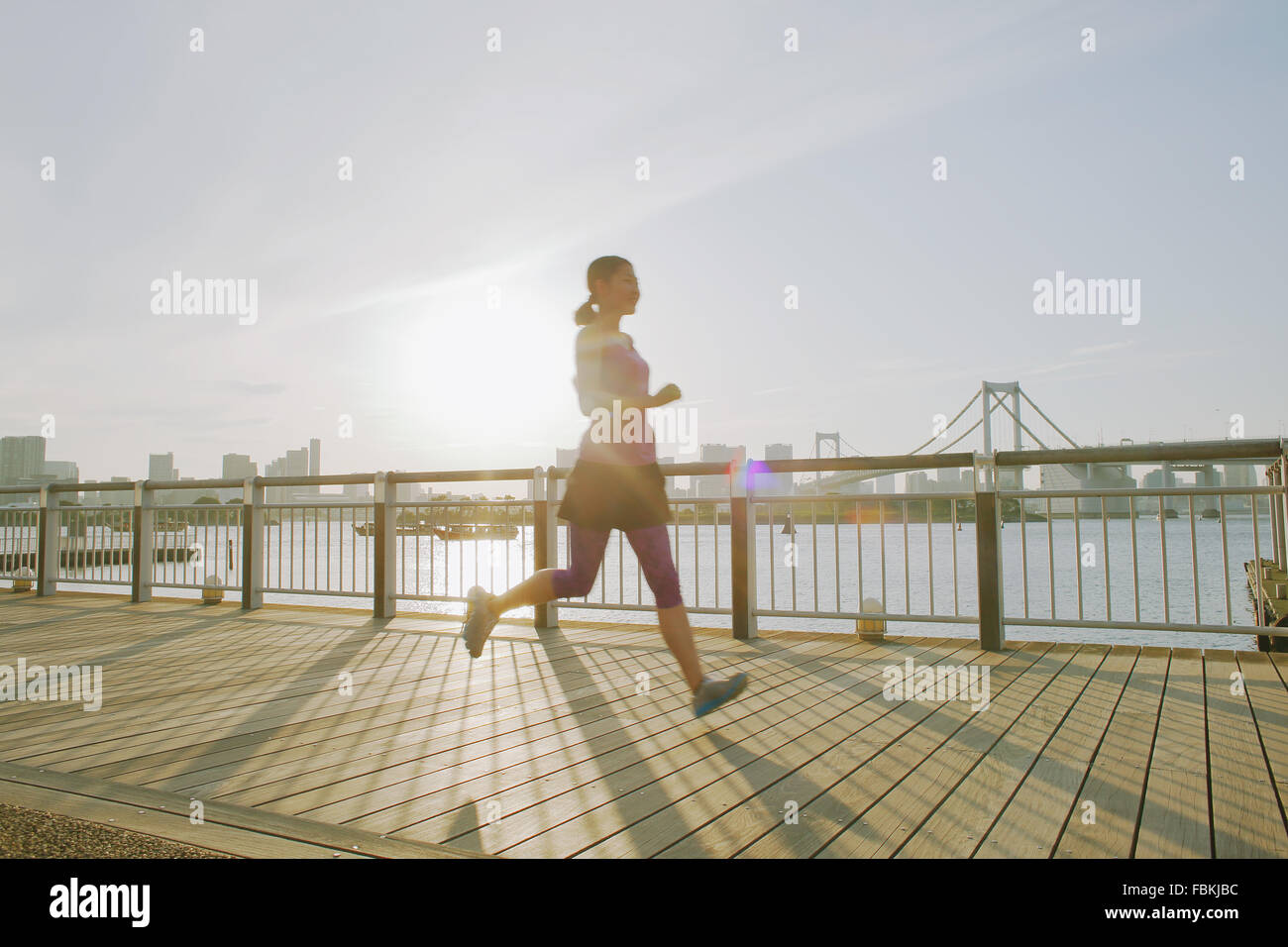 Young Japanese woman running downtown Tokyo Stock Photo - Alamy