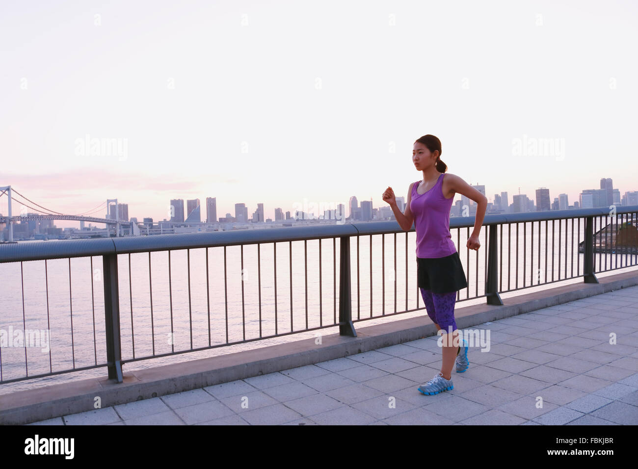 Young Japanese woman running downtown Tokyo Stock Photo - Alamy