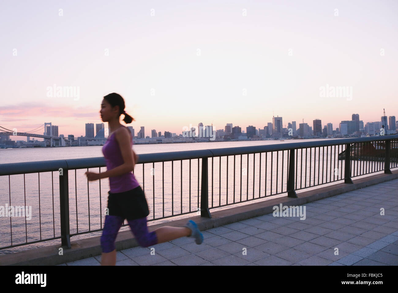 Young Japanese woman running downtown Tokyo Stock Photo - Alamy