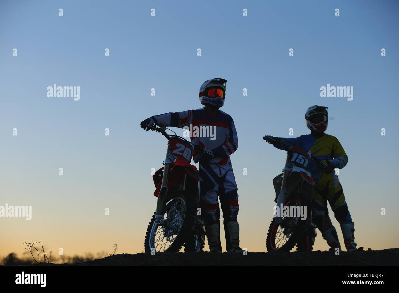 Motocross bikers on dirt track Stock Photo - Alamy