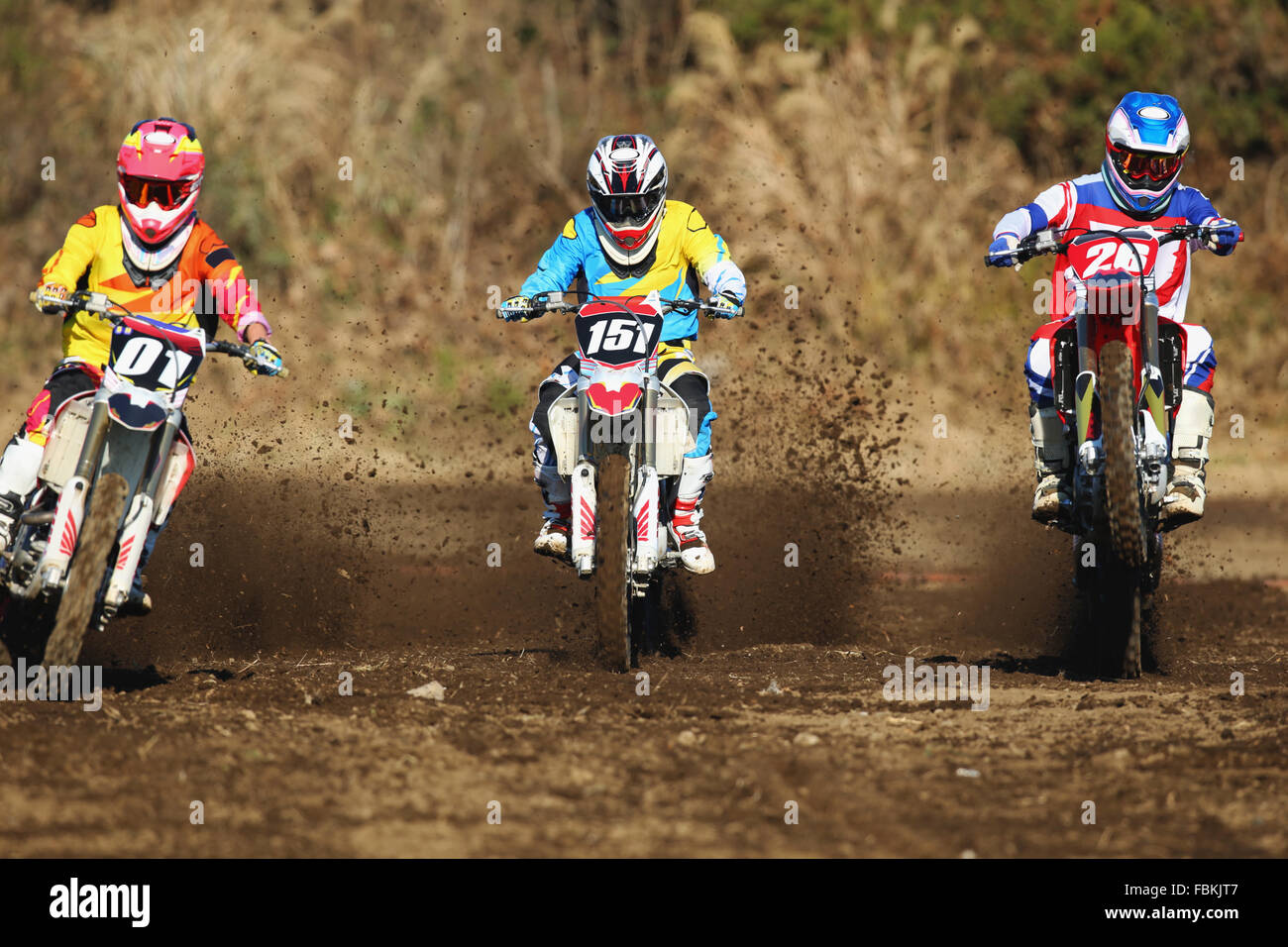 Motocross bikers on dirt track Stock Photo - Alamy