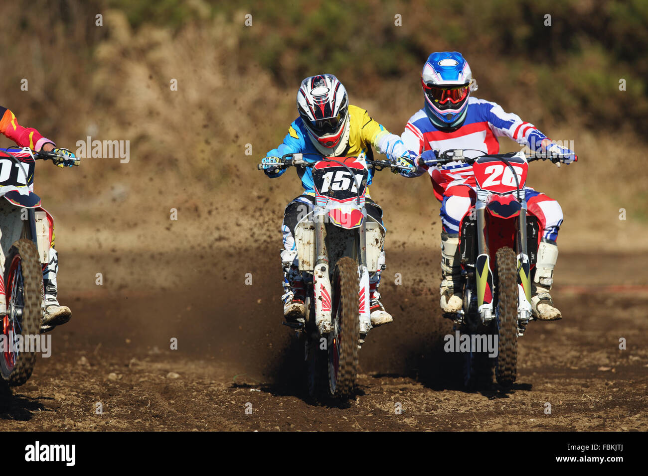 Motocross bikers on dirt track Stock Photo - Alamy