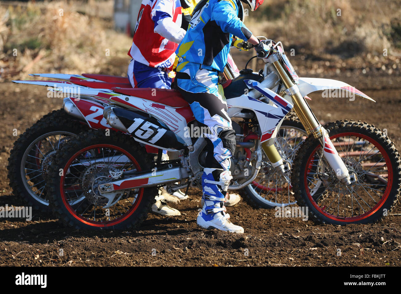 Motocross bikers on dirt track Stock Photo - Alamy