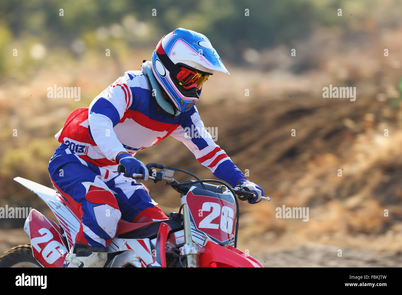 Motocross biker on dirt track Stock Photo - Alamy