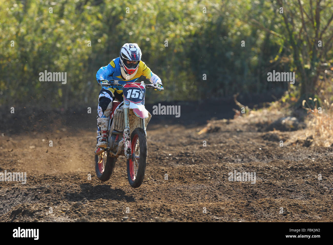 Motocross biker on dirt track Stock Photo - Alamy