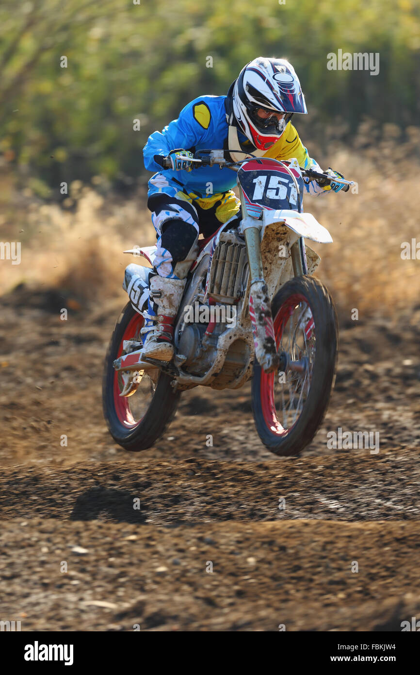 Motocross biker on dirt track Stock Photo - Alamy