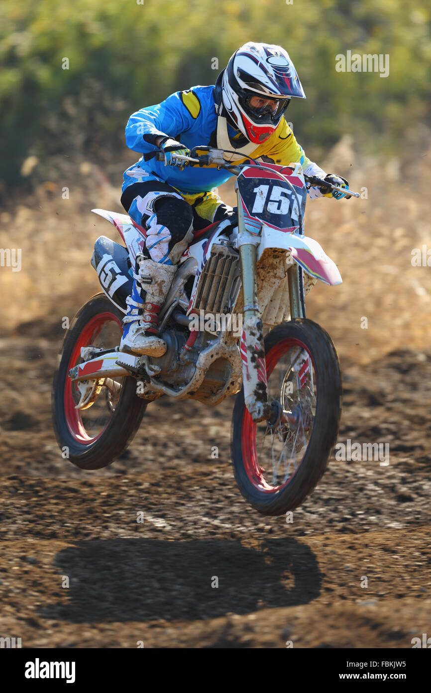 Motocross biker on dirt track Stock Photo - Alamy