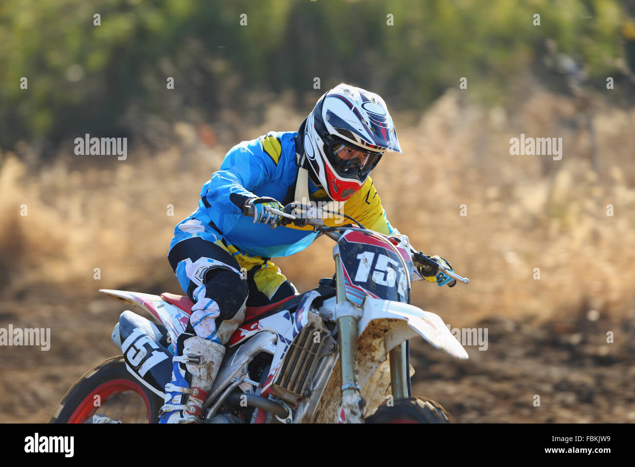 Motocross biker on dirt track Stock Photo - Alamy