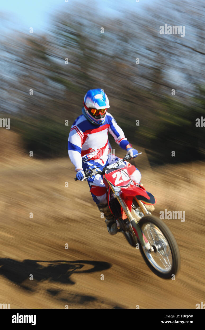Motocross biker on dirt track Stock Photo - Alamy