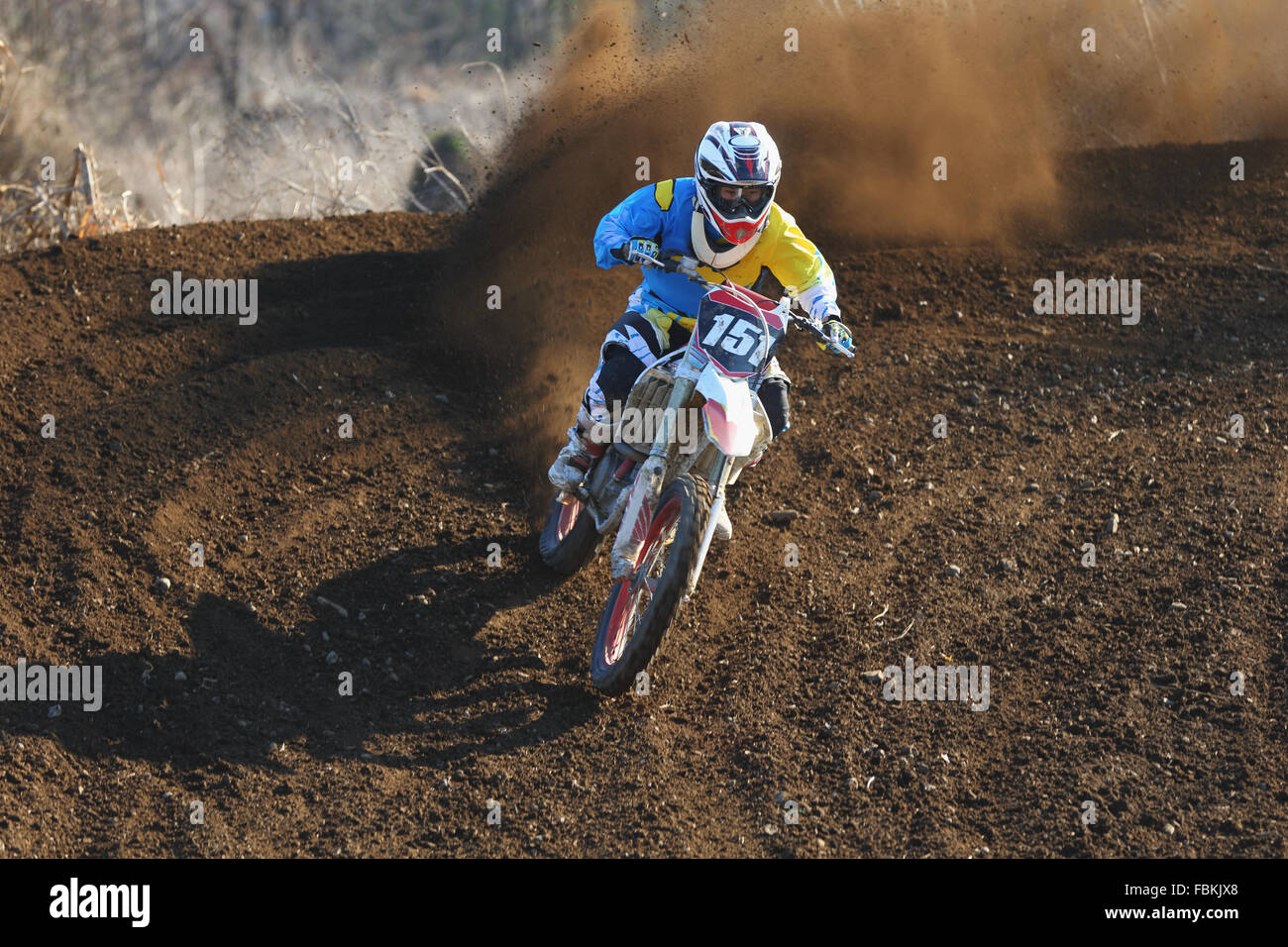 Motocross biker on dirt track Stock Photo - Alamy