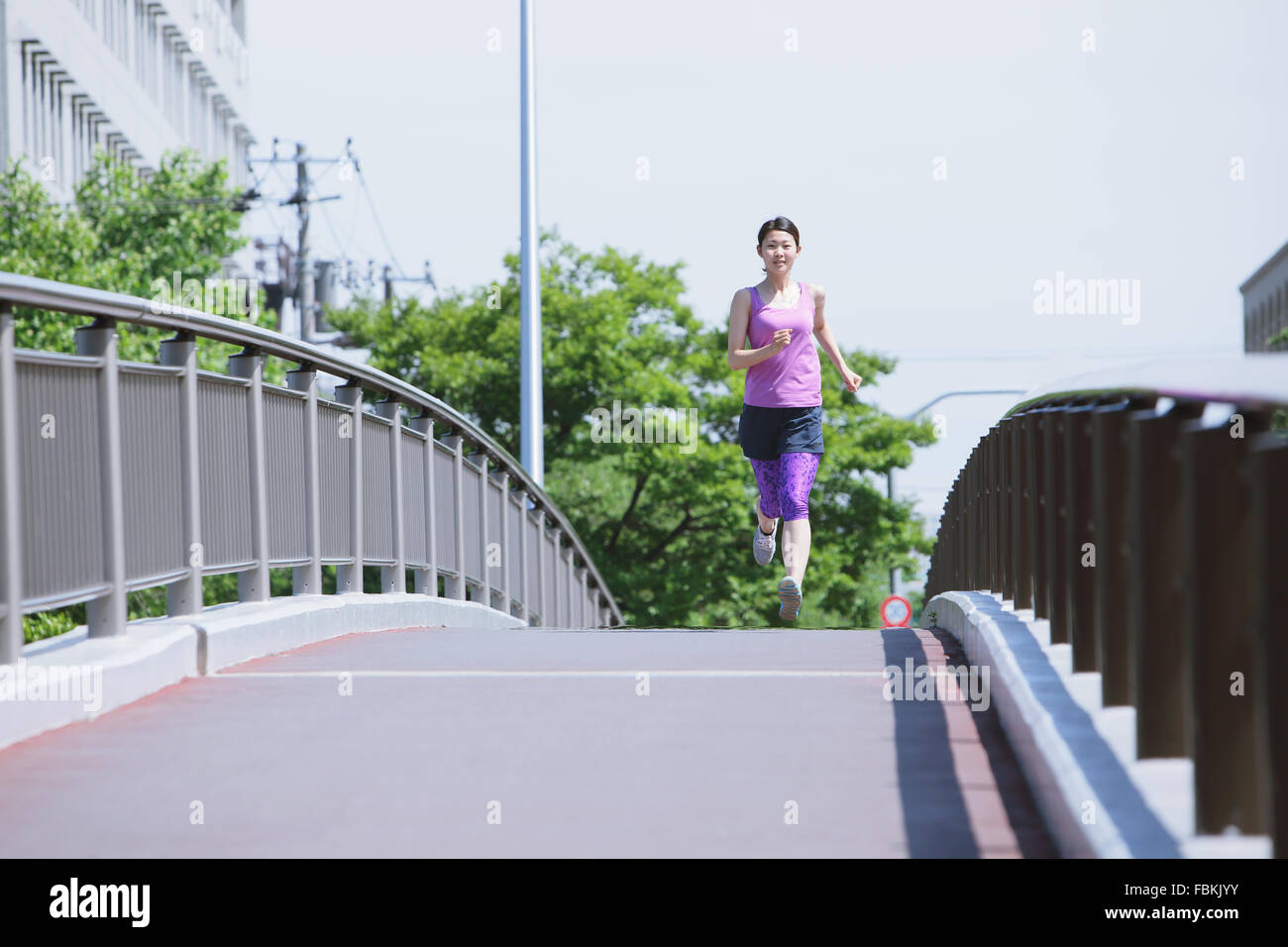 Young Japanese woman running downtown Tokyo Stock Photo - Alamy