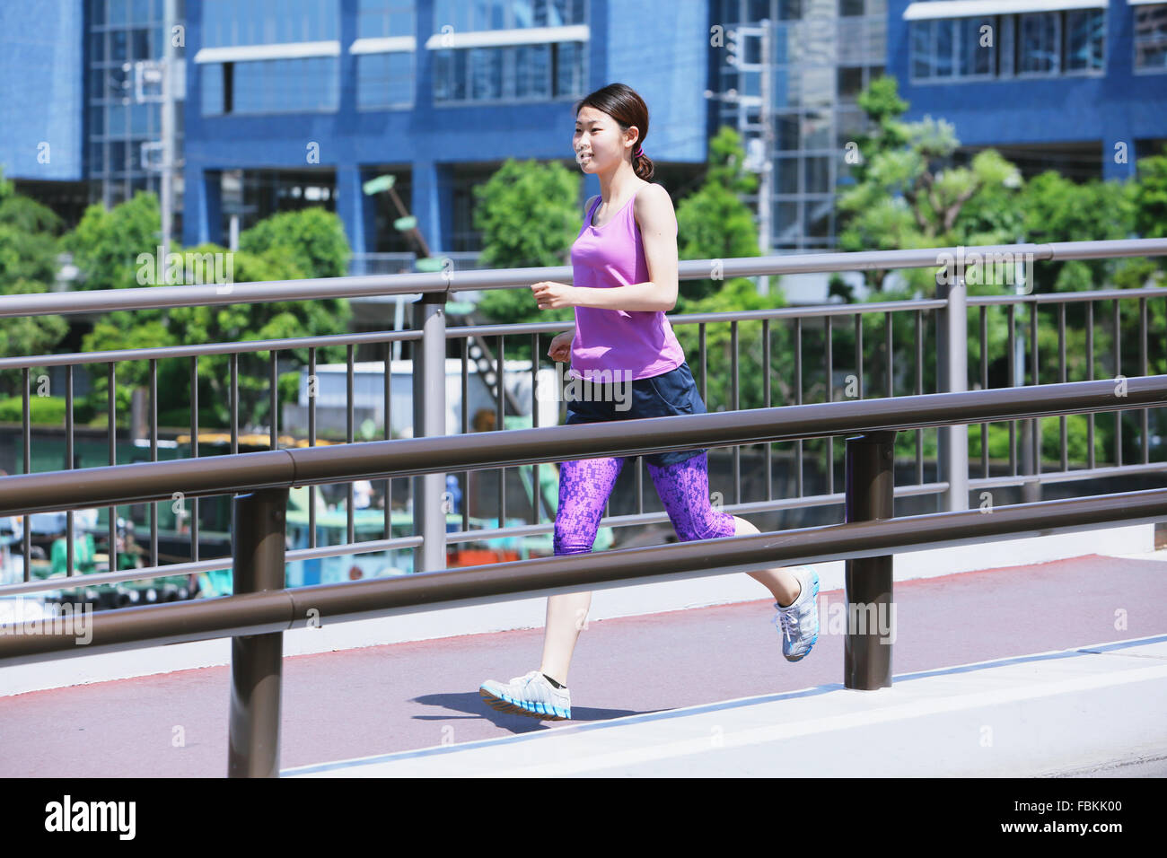 Young Japanese woman running downtown Tokyo Stock Photo - Alamy